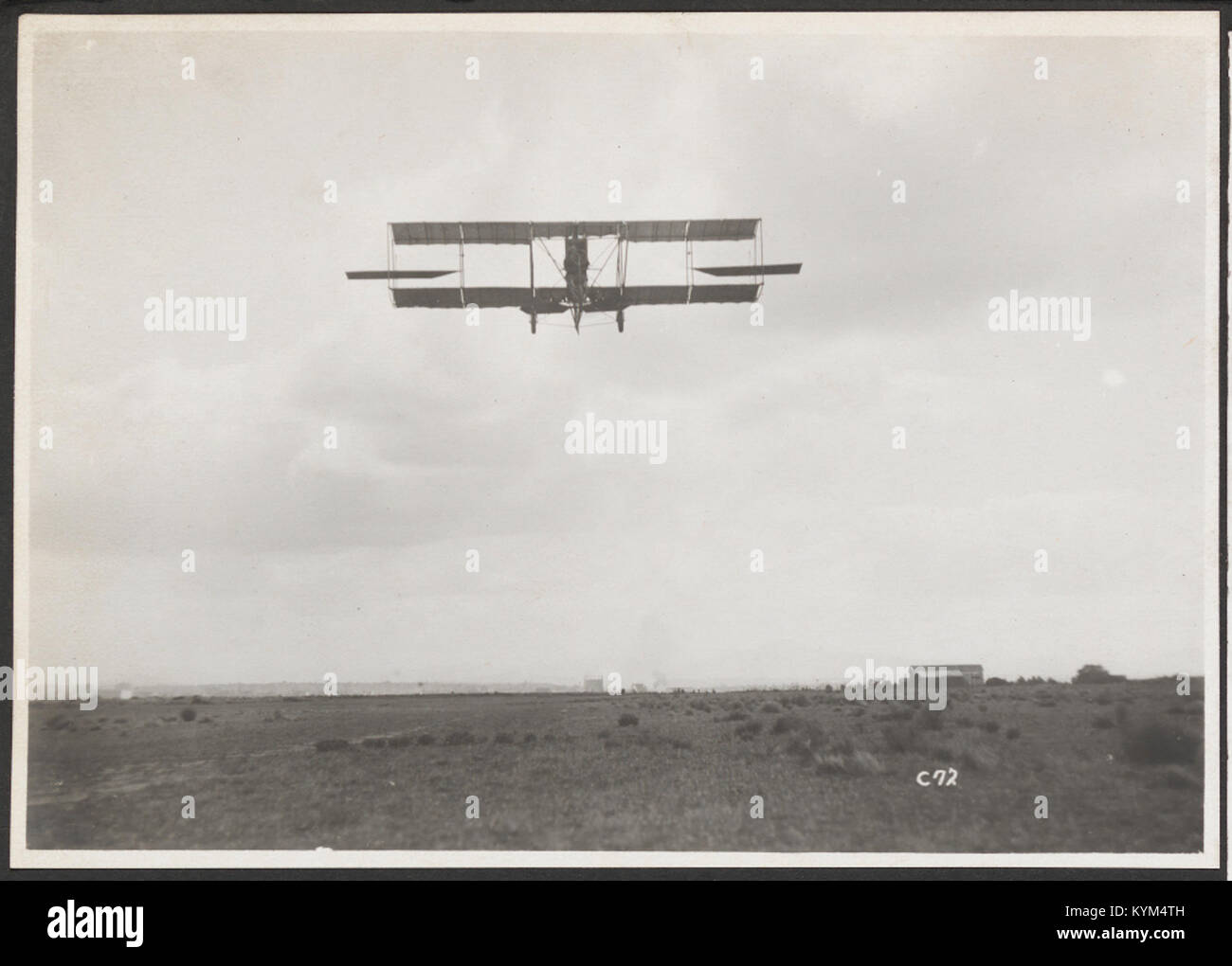 A Curtiss Pusher aircraft in flight above North Island, San Diego. This ...