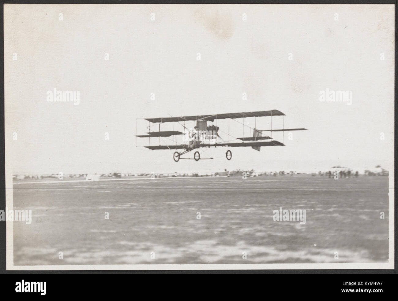 A historical image of a Curtiss Pusher biplane making a landing ...