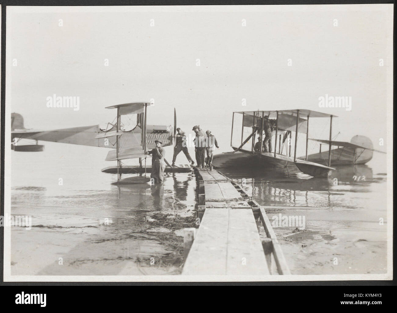 Floatplane and seaplane at the end of a pier, showcasing early aviation ...