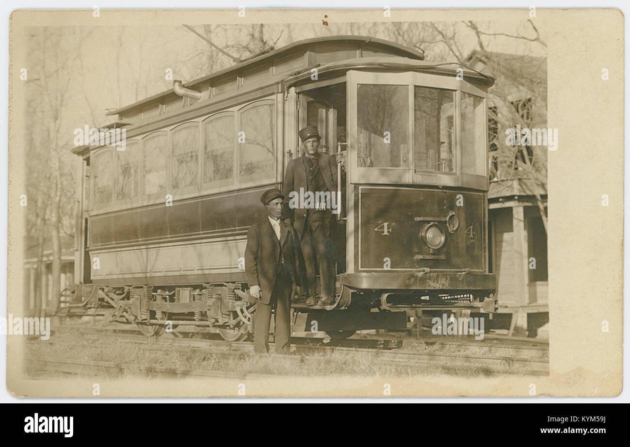 A historical photograph showing men standing by a streetcar in Fort ...