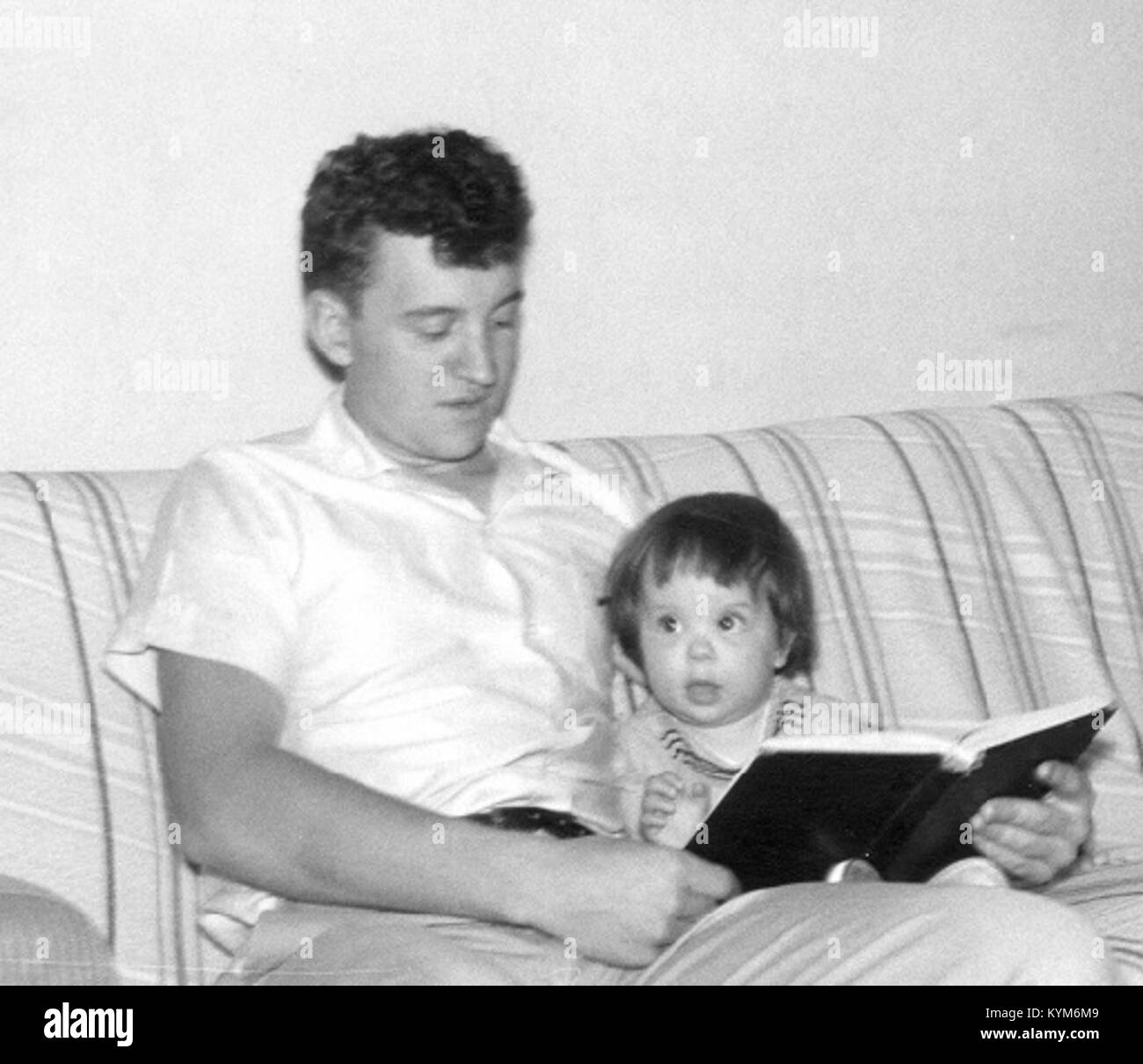 A photograph showing I Weaver reading to Grace Cory in Pueblo, Colorado ...