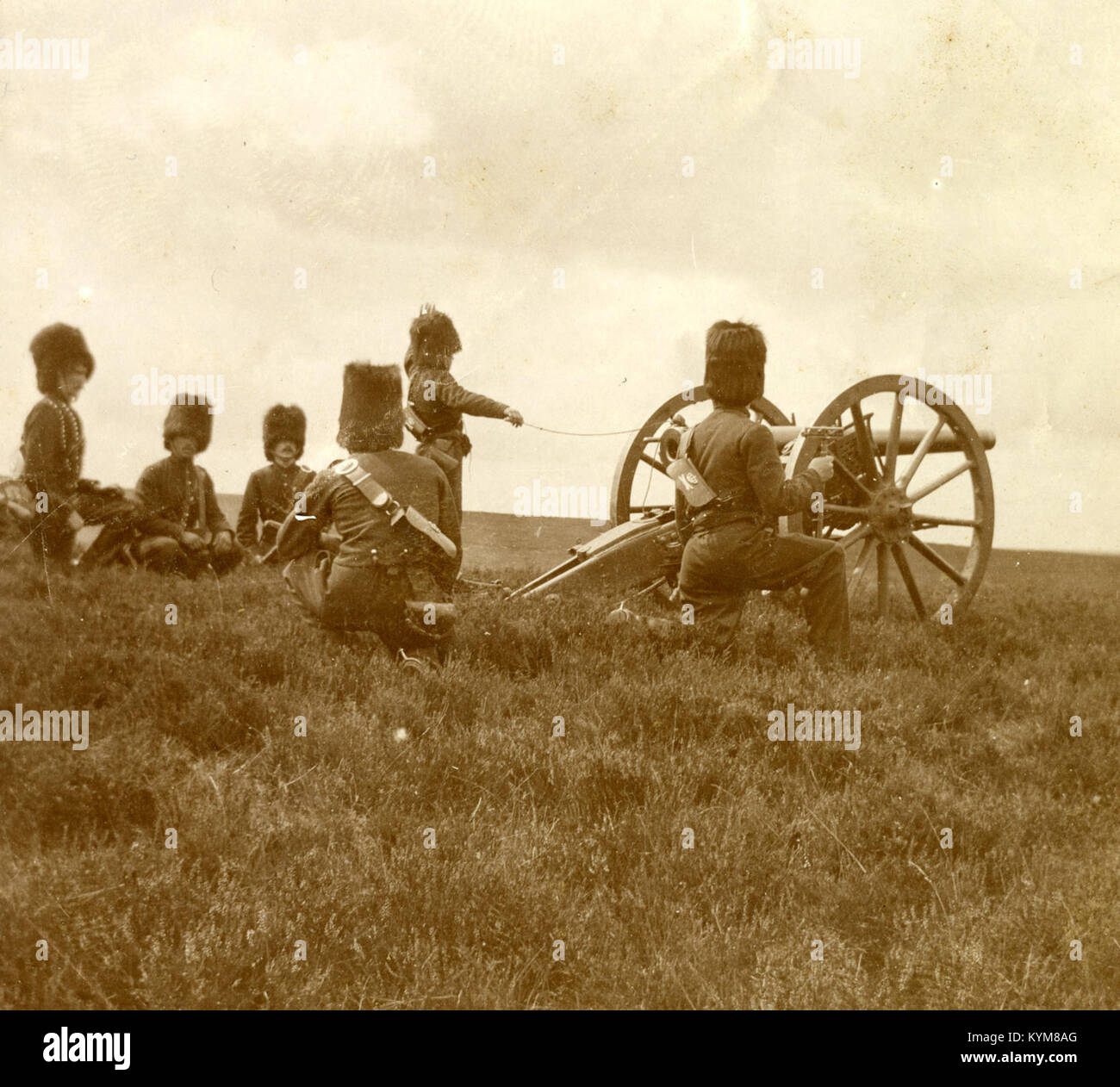A historical photograph of artillerymen operating a large cannon during ...