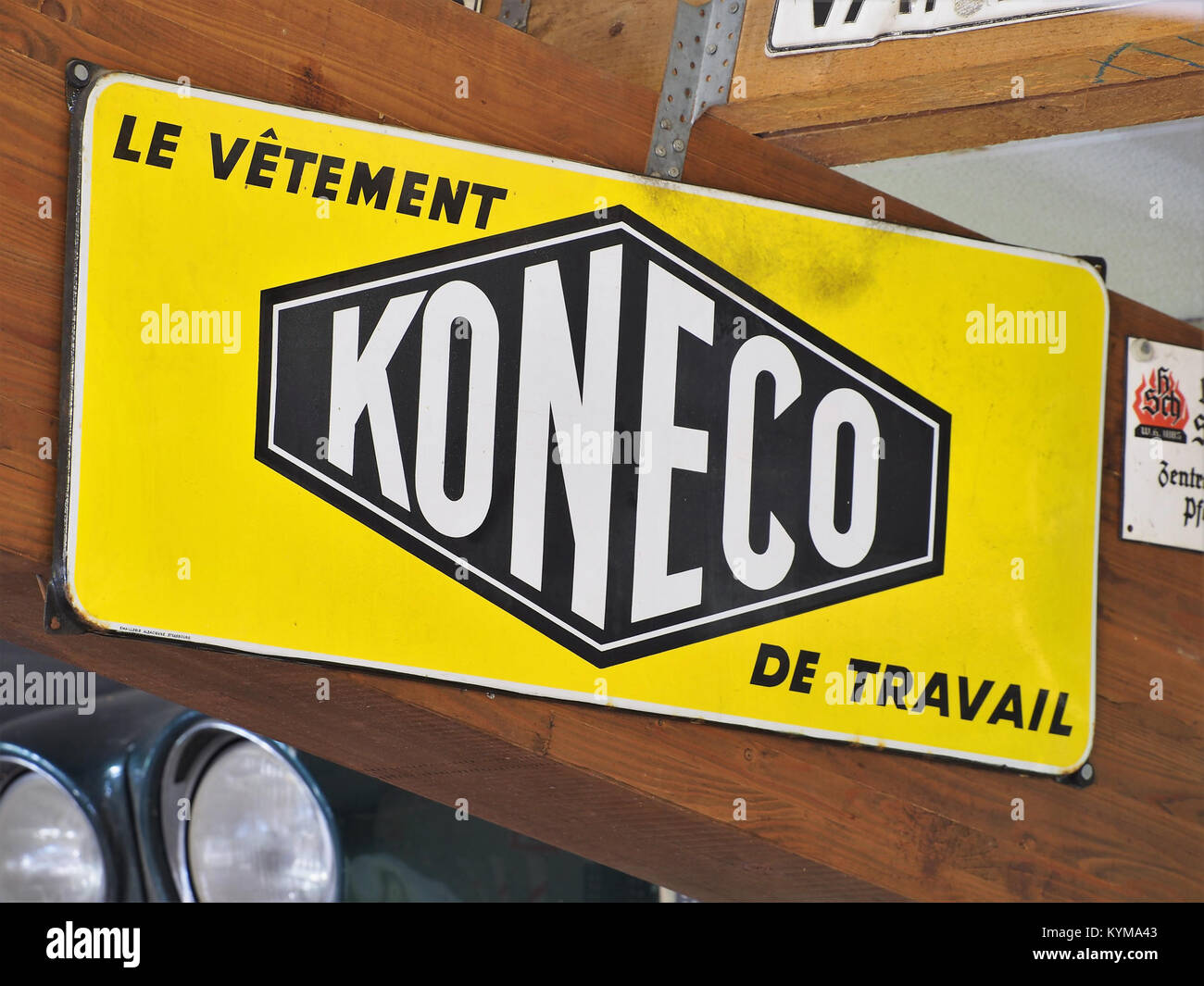 A vintage enamel advertisement for Koneco, a workwear brand, displayed ...