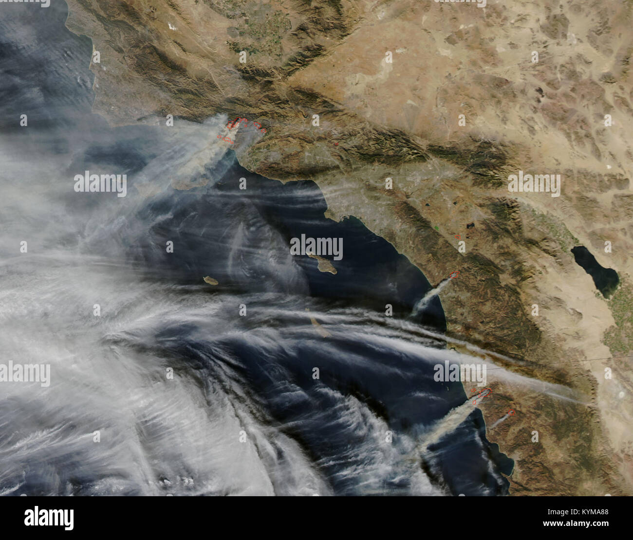 A photograph taken from space showing columns of smoke rising from a ...