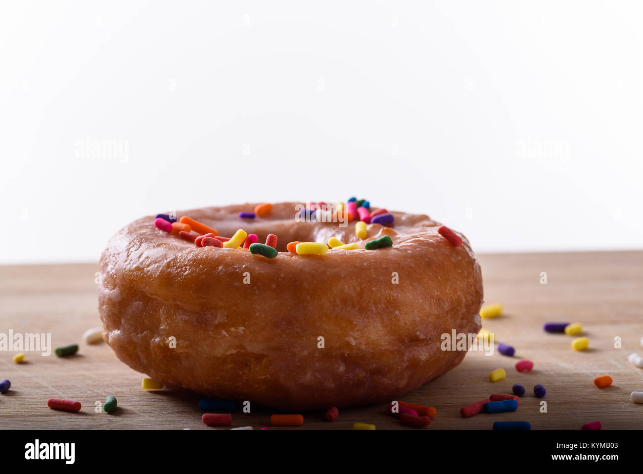 Donut with sprinkles on a white background, fresh donut side view Stock ...