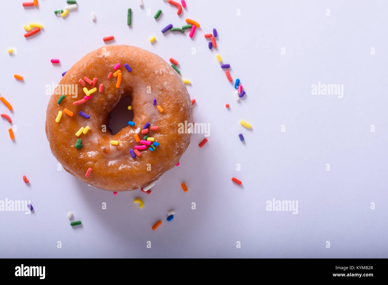 Top view of a Donut with sprinkles on a white background with negative ...