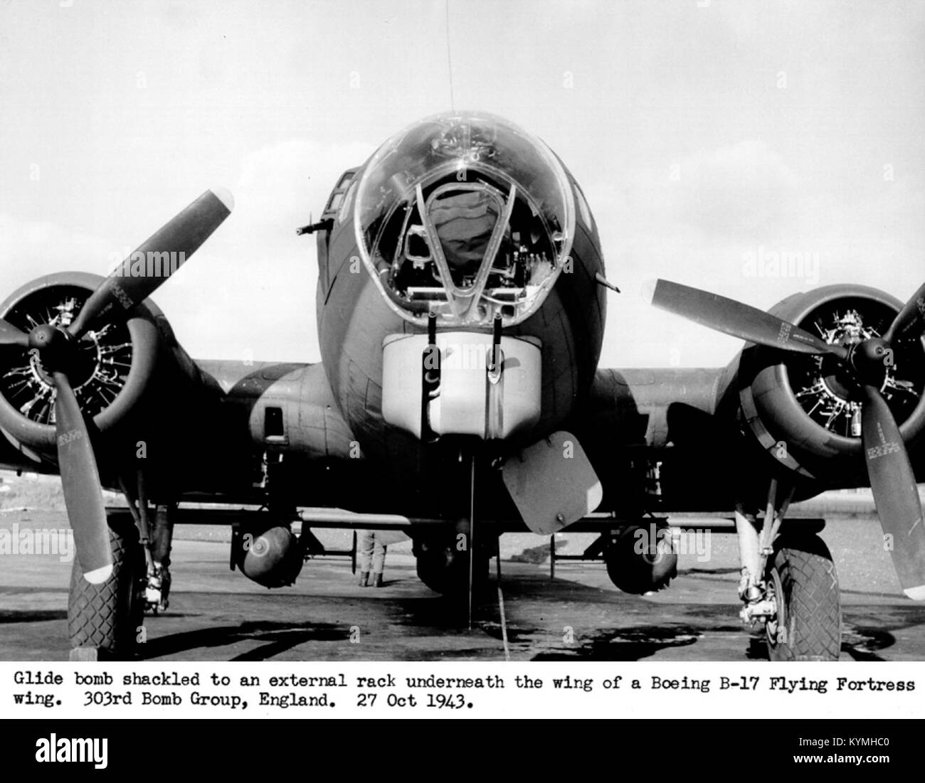 A historical photograph of a Boeing B-17 Flying Fortress in flight. The ...