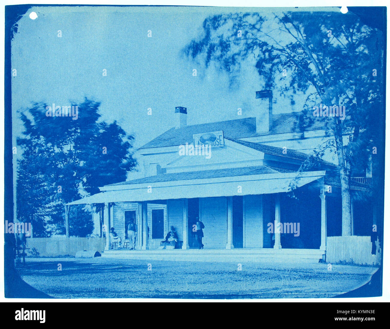 A late 19th-century cyanotype photograph of a house with a chimney ...