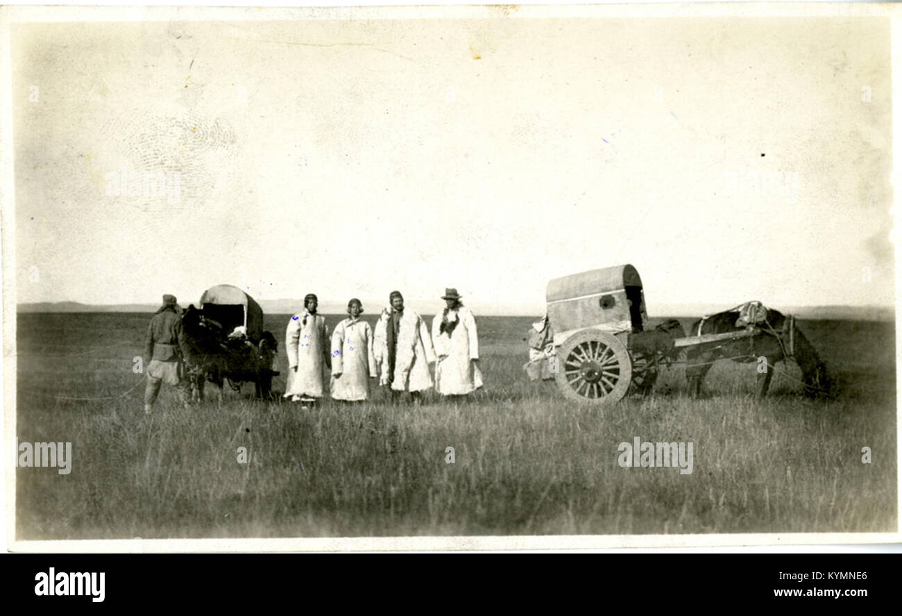 This image depicts a group of people, carts, and horses in China ...