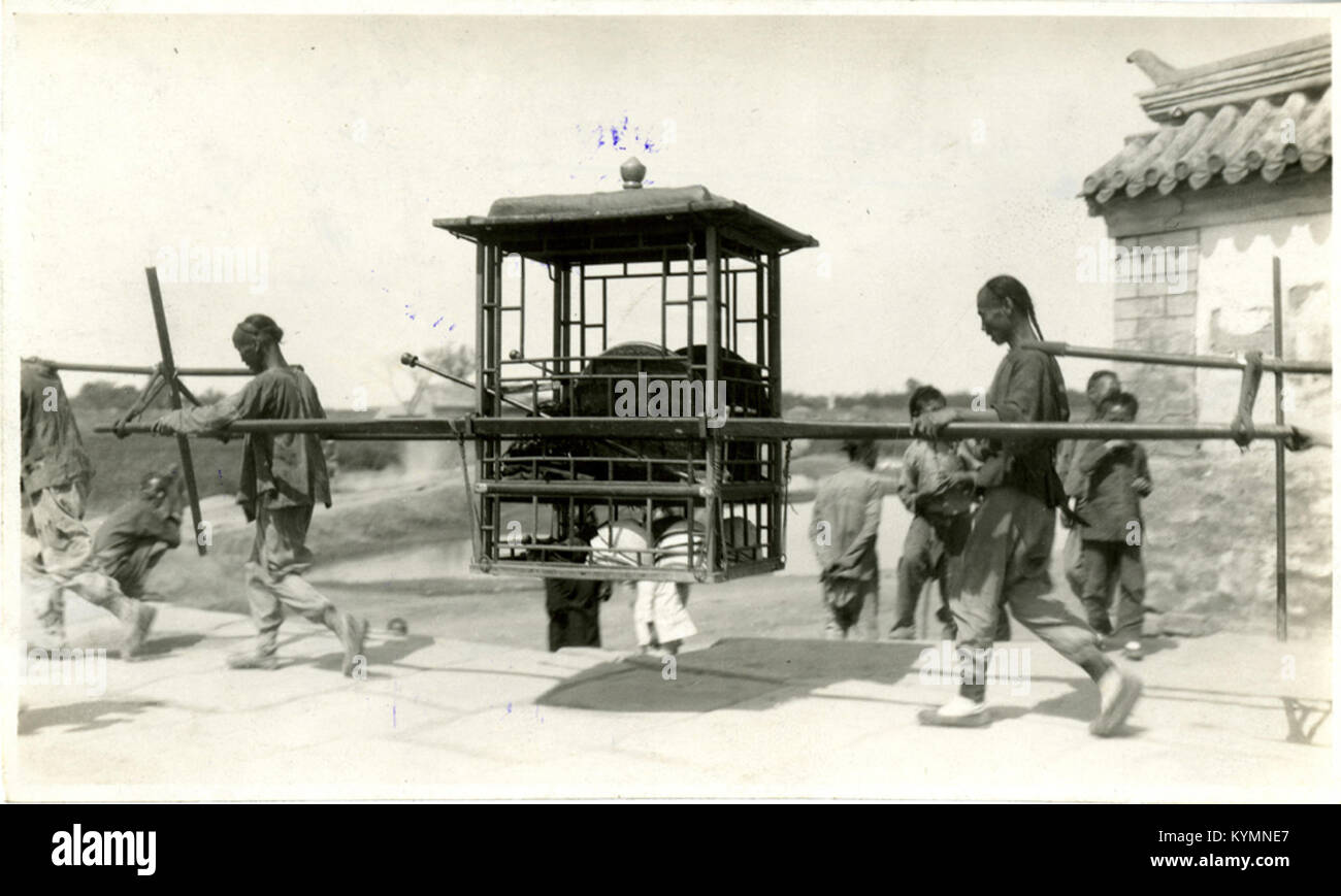 A historical photograph of Chinese men carrying a litter, showcasing ...