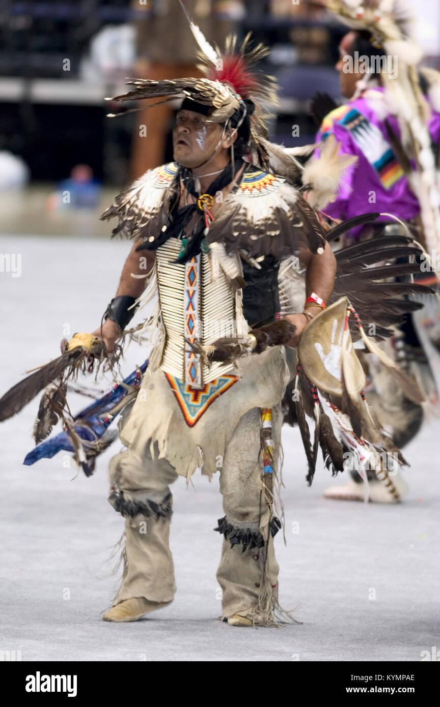 A Native American male performs in traditional regalia during a ...