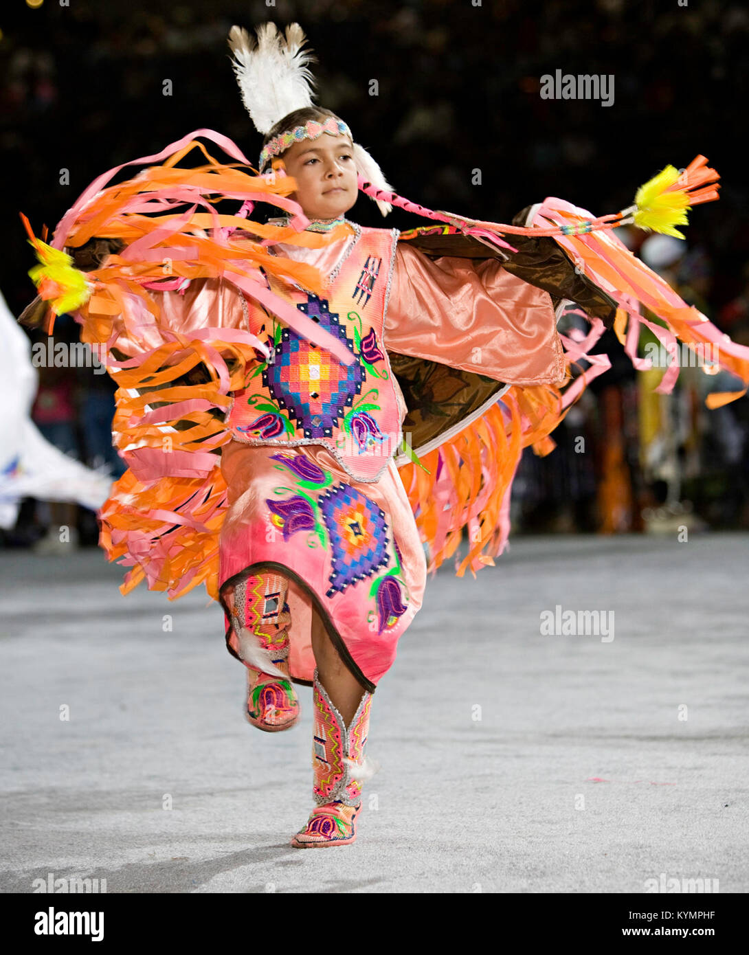 Photograph from the 2007 Powwow featuring a child dancer wearing a head ...