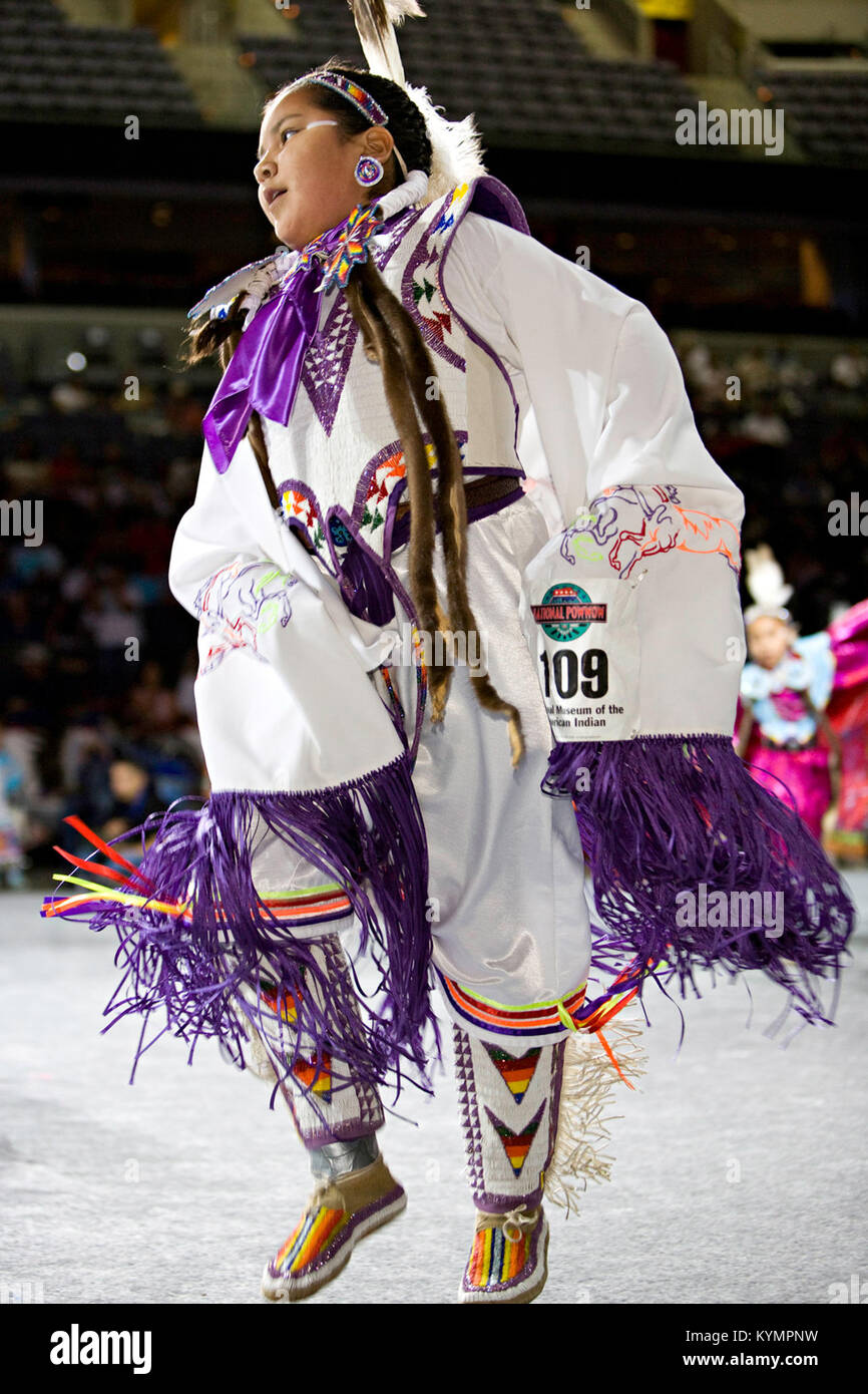 This image depicts a young Native American dancer participating in a ...