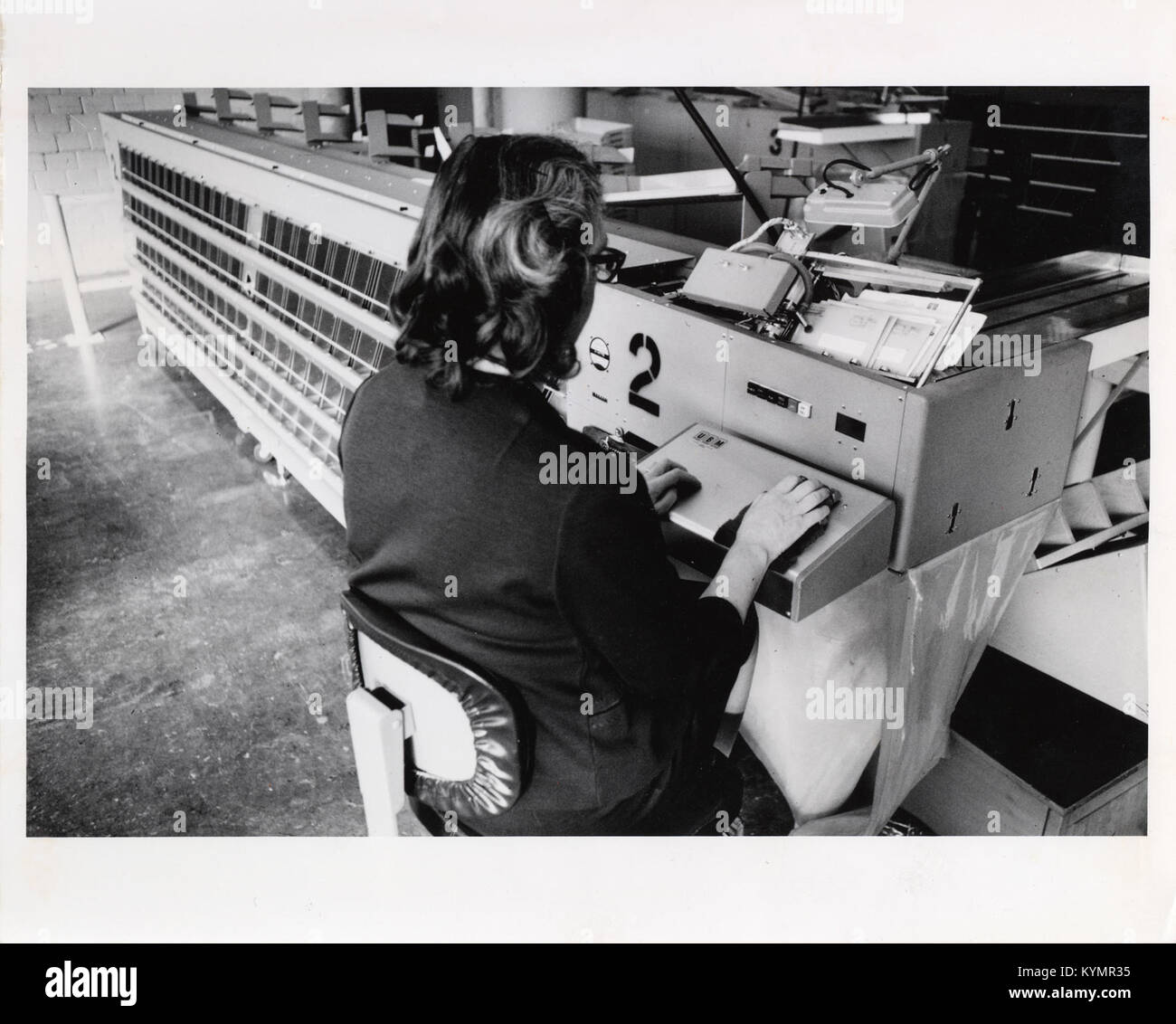 A photograph of a woman working in a mail processing center in 1965 ...