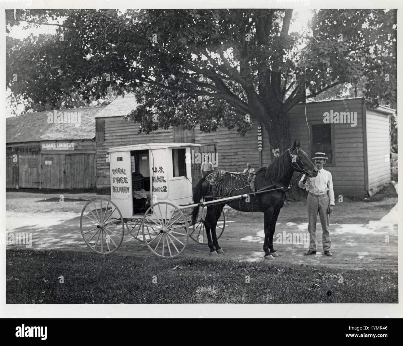 A historic photograph showing a rural carrier using a horse and wagon ...