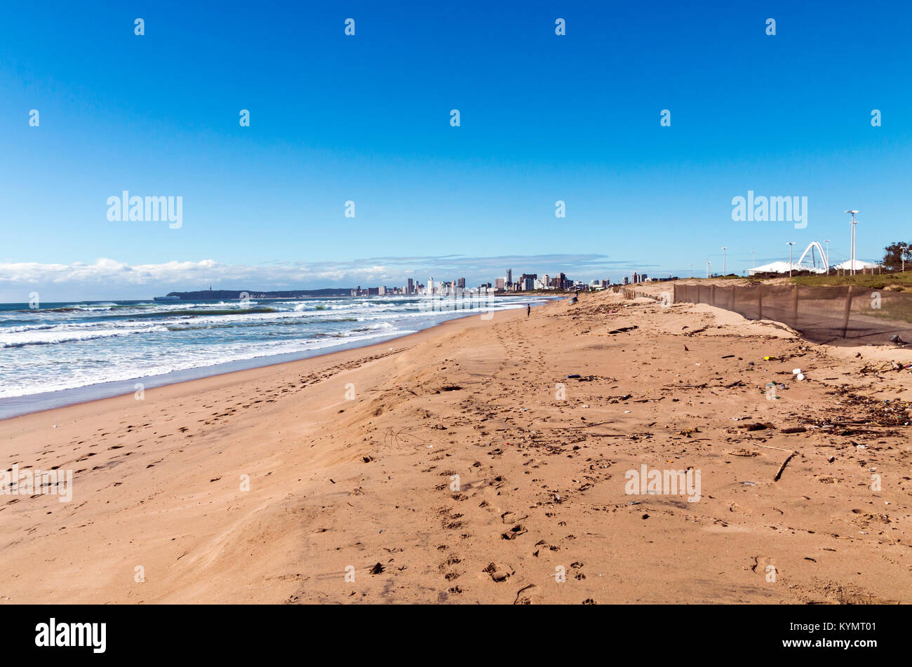 Early morning beach and sea against blue sky and city skyline in Durban ...