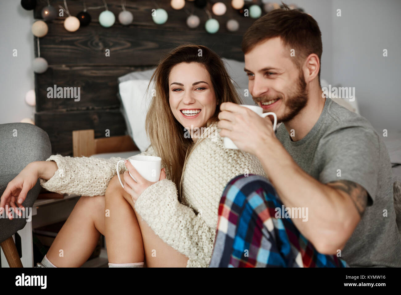 Young couple drinking coffee in bed Stock Photo - Alamy
