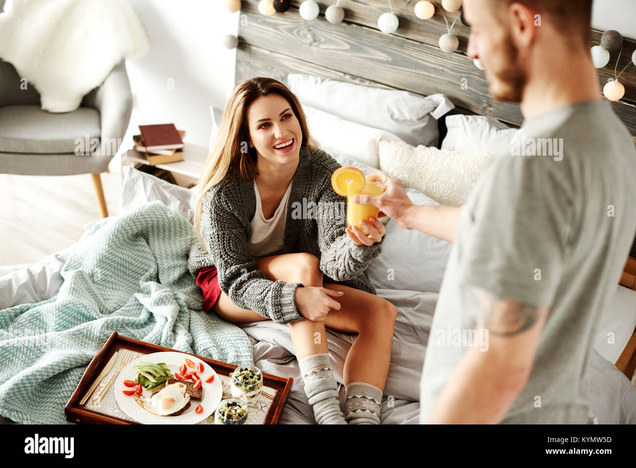 Affectionate man serving breakfast for woman Stock Photo - Alamy