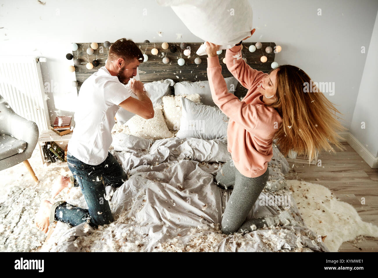 Affectionate couple and pillow fight at bedroom Stock Photo - Alamy