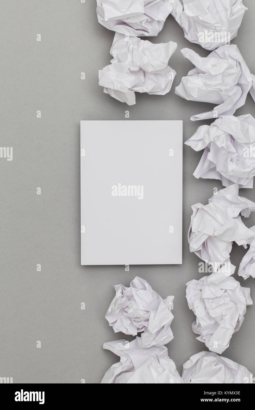 Blank white card postcard flyer on a grey background with crumpled ...