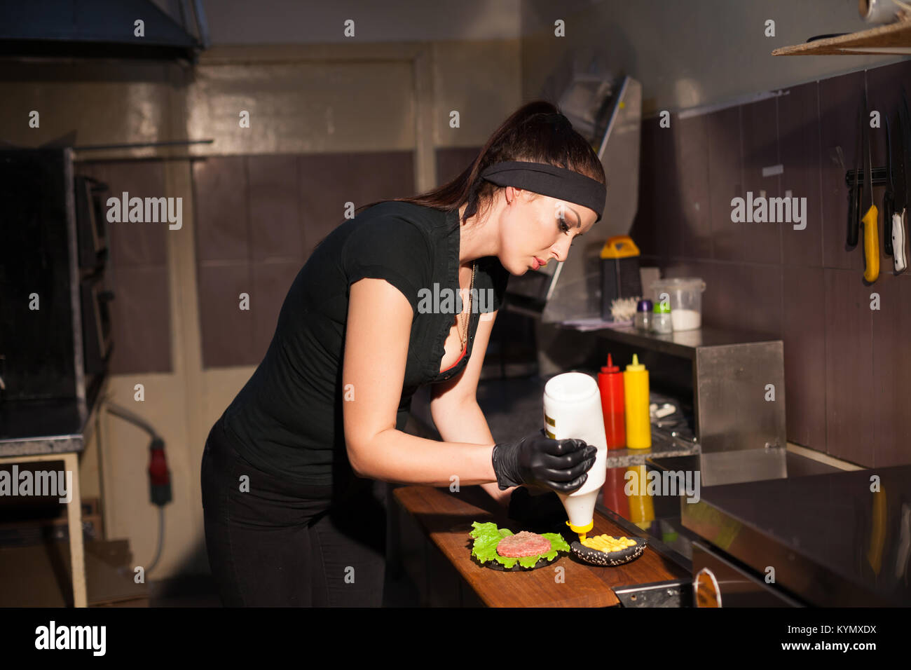 beautiful girl Cook prepares the kitchen Burger Stock Photo - Alamy