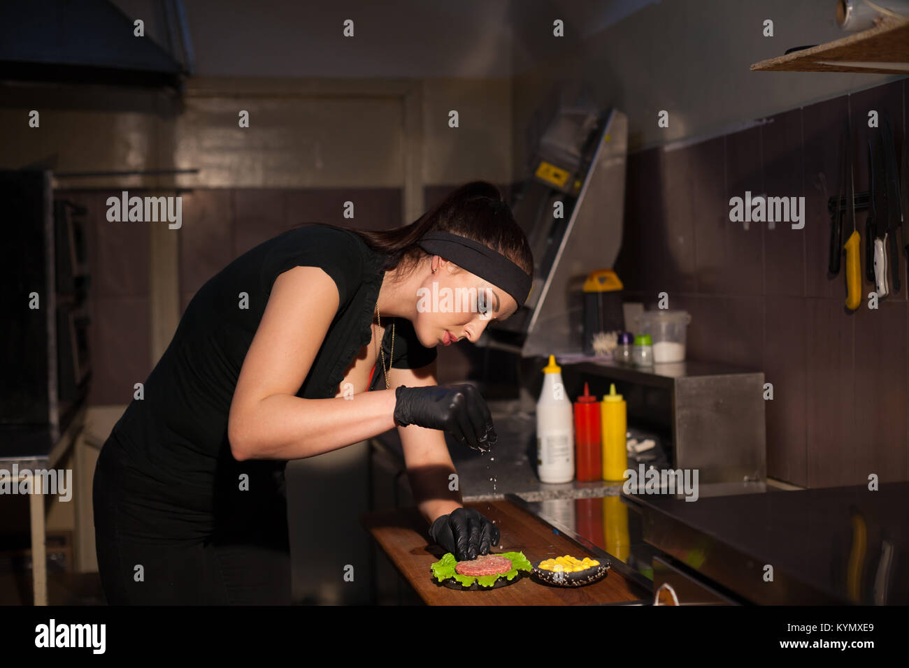 beautiful girl Cook prepares the kitchen Burger Stock Photo - Alamy