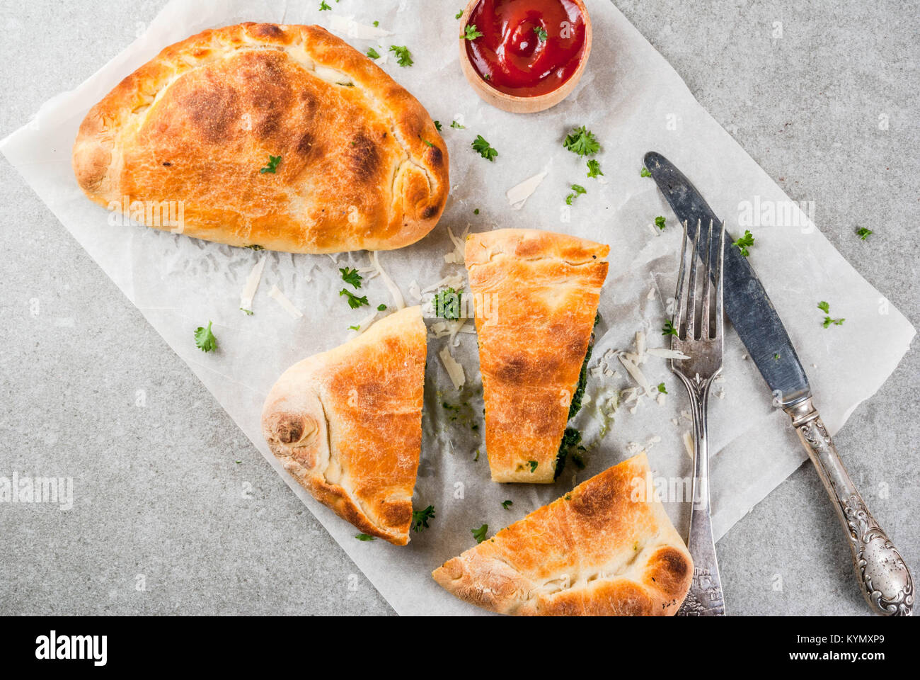 Italian food, closed pizza calzone with Spinach and Cheese, gray stone ...