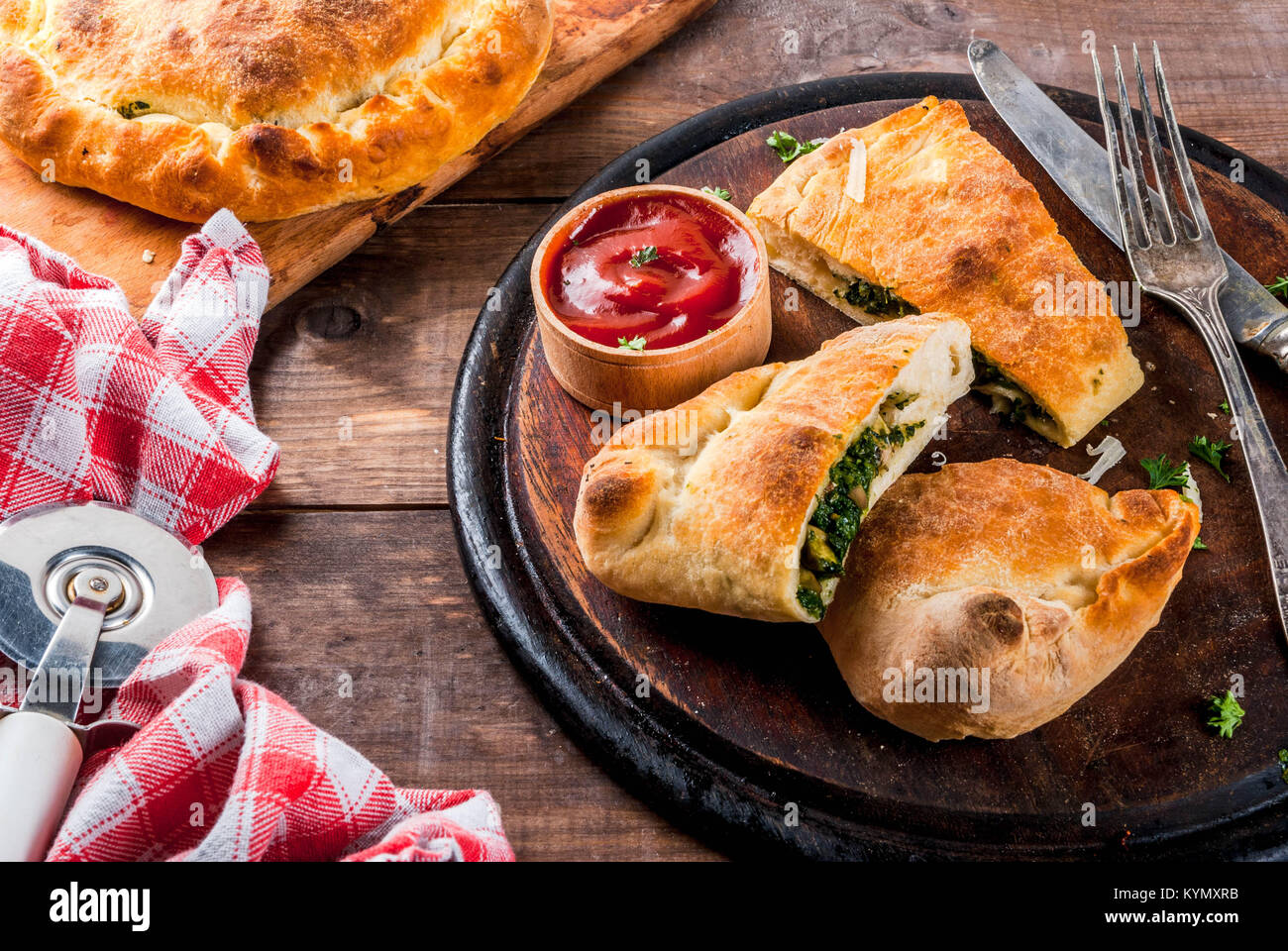 Italian food, closed pizza calzone with Spinach and Cheese, wooden ...