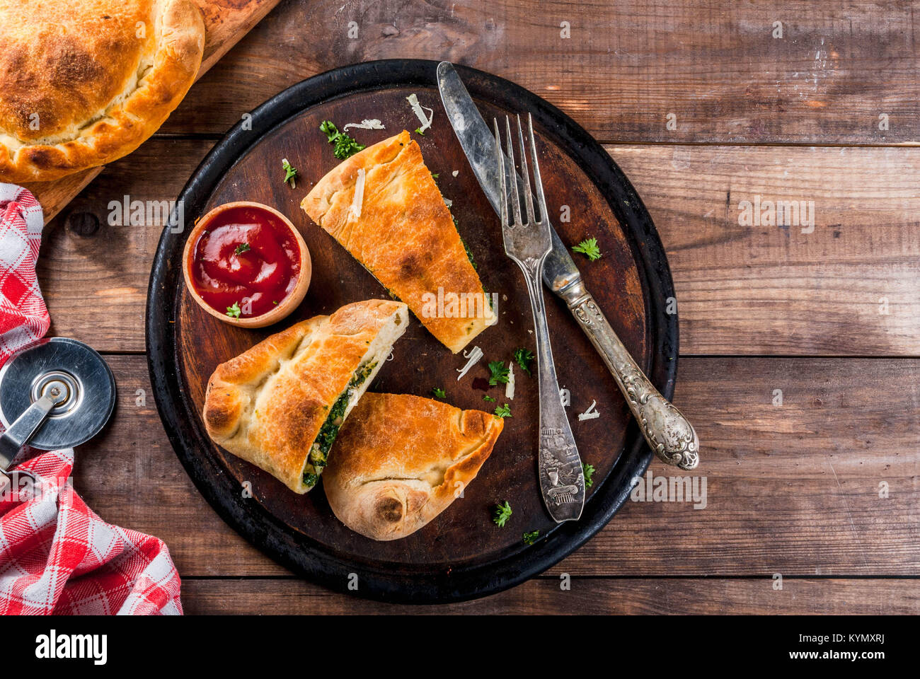 Italian food, closed pizza calzone with Spinach and Cheese, wooden ...