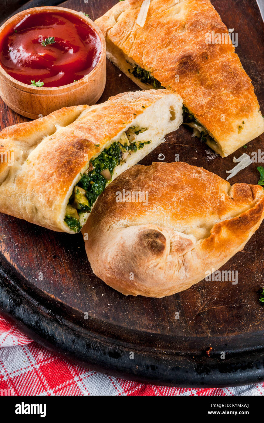 Italian food, closed pizza calzone with Spinach and Cheese, wooden ...