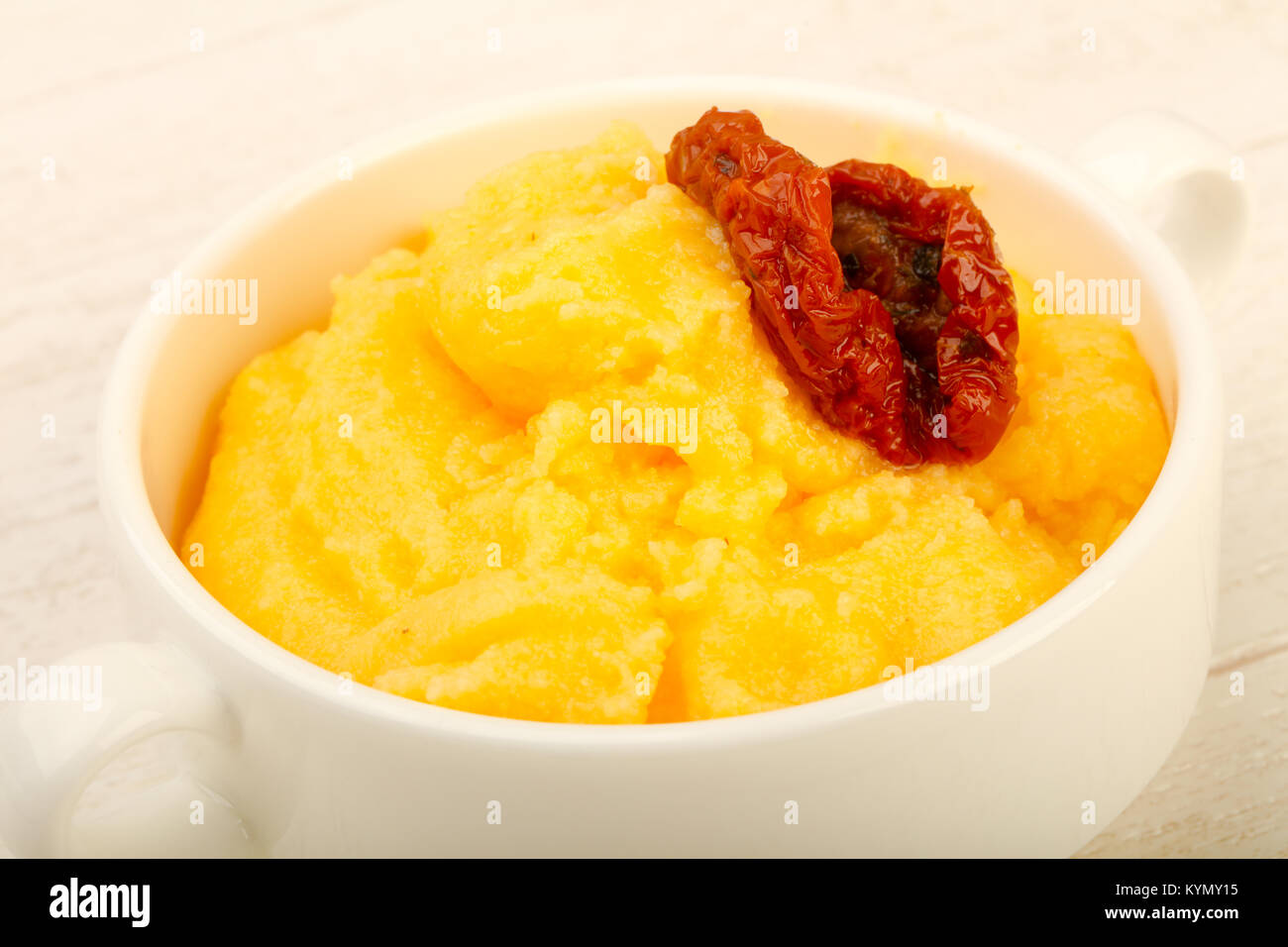 Polenta with dry tomato Stock Photo - Alamy