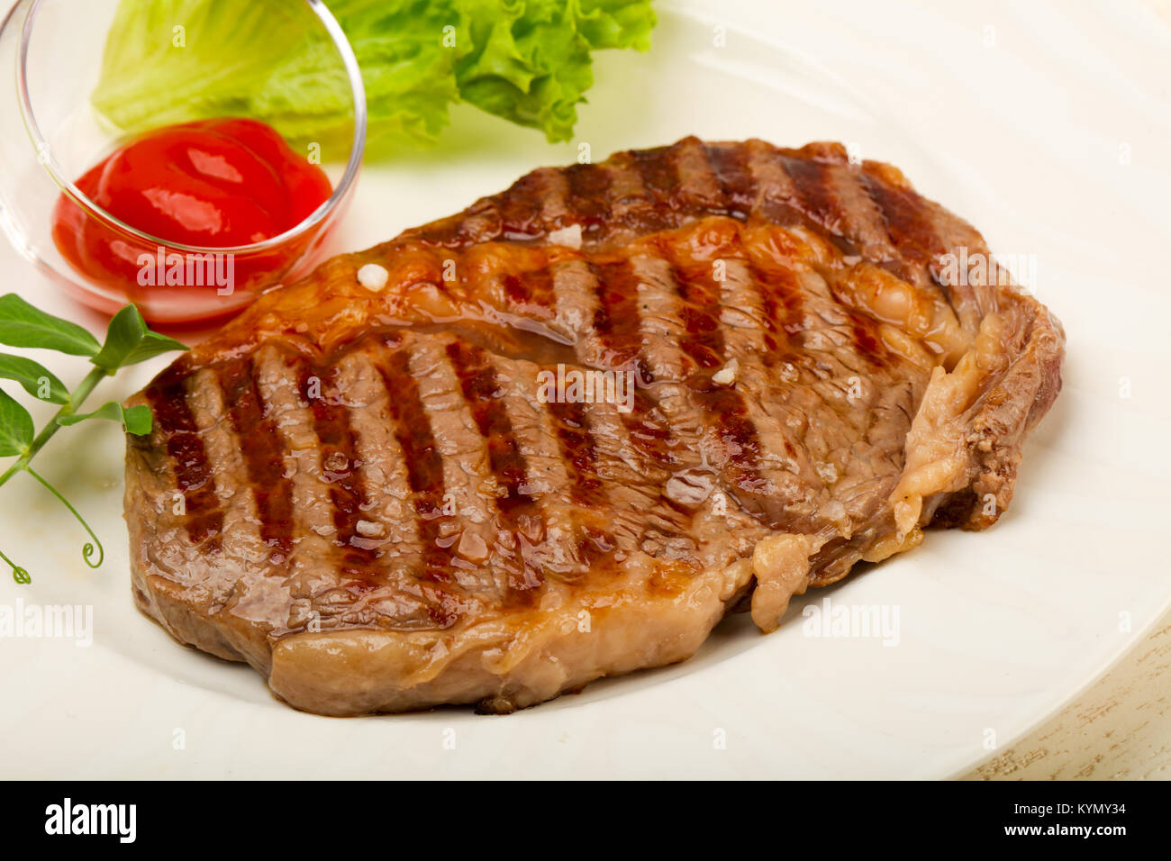 Grilled Rib eye steak with sauce Stock Photo - Alamy