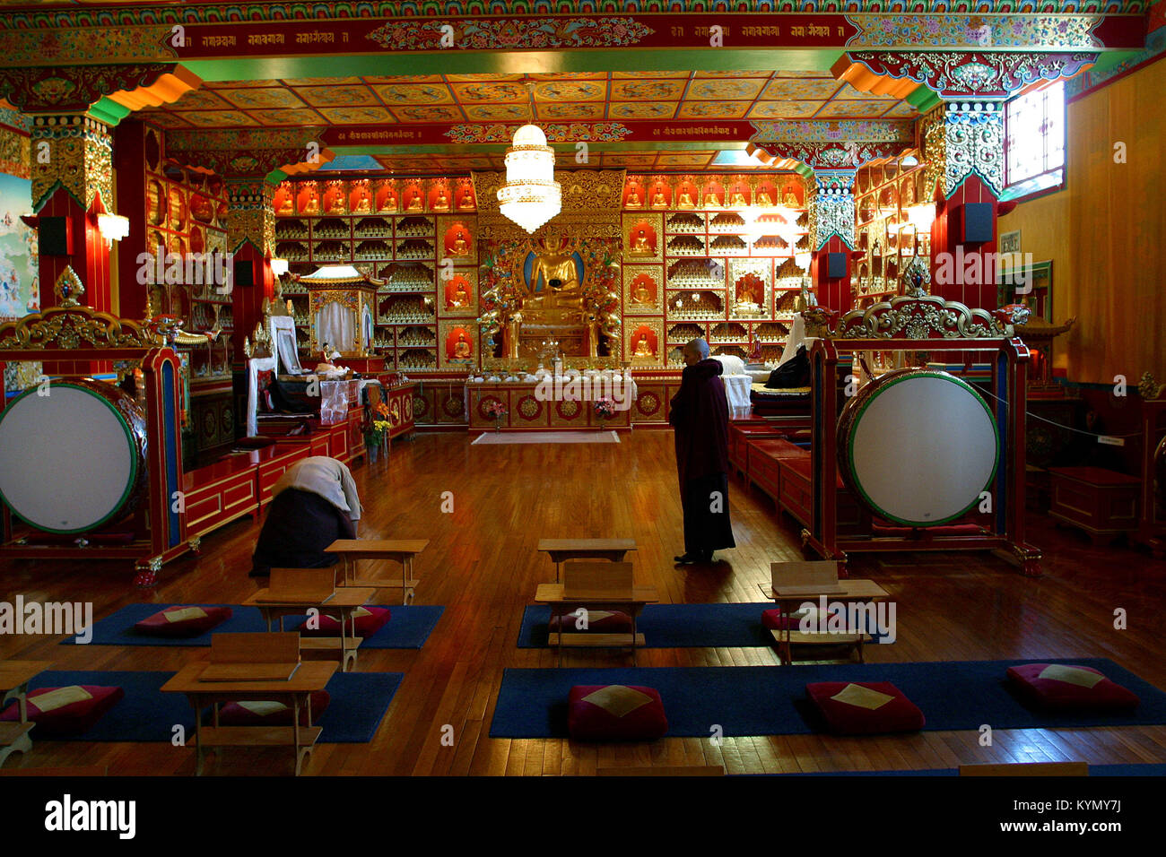 A monk and a nun pictured during afternoon prayers in the temple of the ...