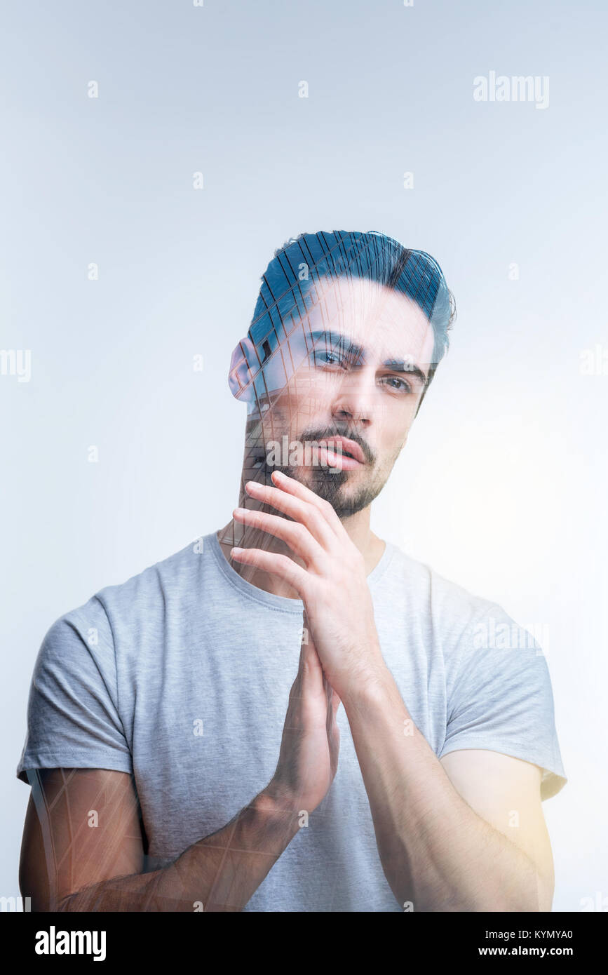 Striking handsome man evaluating his project Stock Photo - Alamy