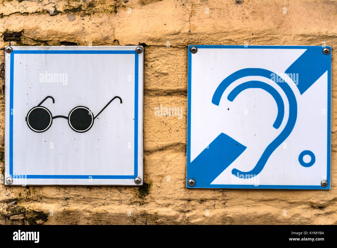 Visual and hearing disability signs on wall Stock Photo - Alamy