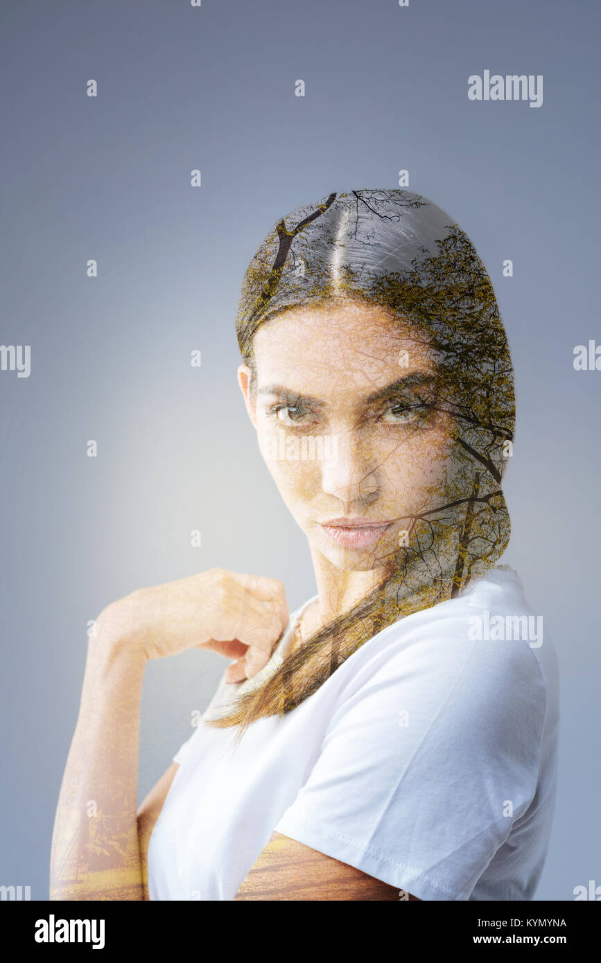 Determined thoughtful woman magnifying with her look Stock Photo - Alamy
