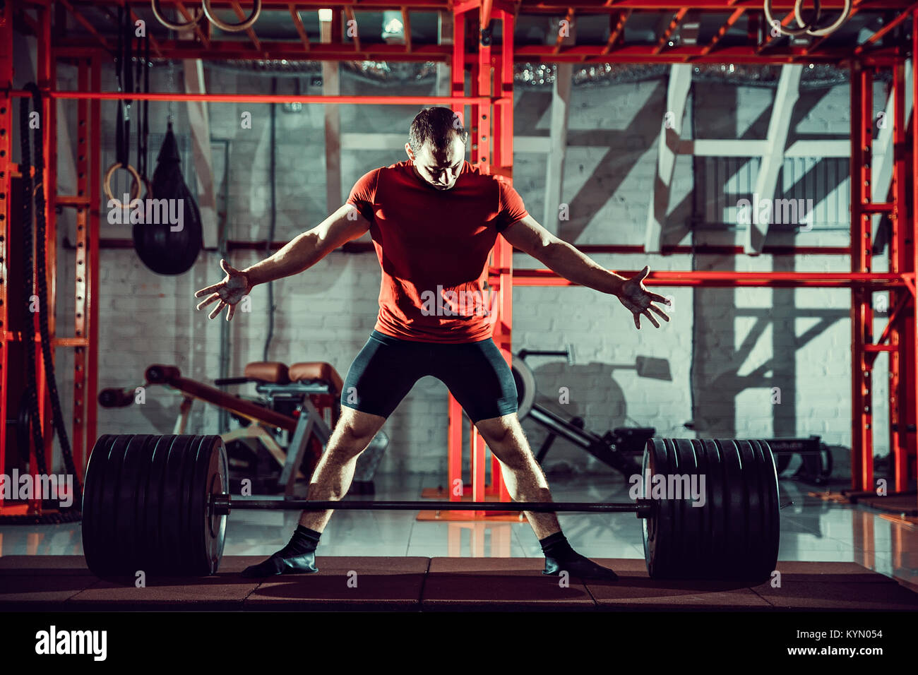 Strong muscular man preparing for workout in crossfit gym. Young ...