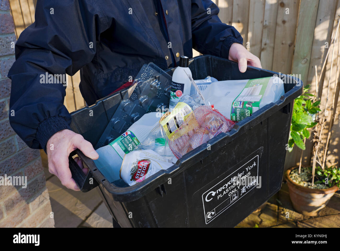 Close up of person man collecting holding carrying plastic and tin ...