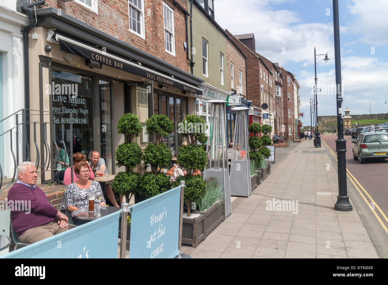 Customers sit outside bars and cafes on the high street in Tynemouth ...