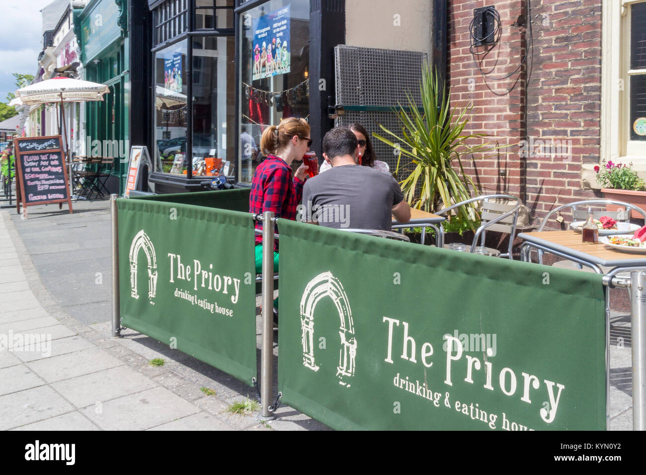 Customers sit outside bars and cafes on the high street in Tynemouth ...