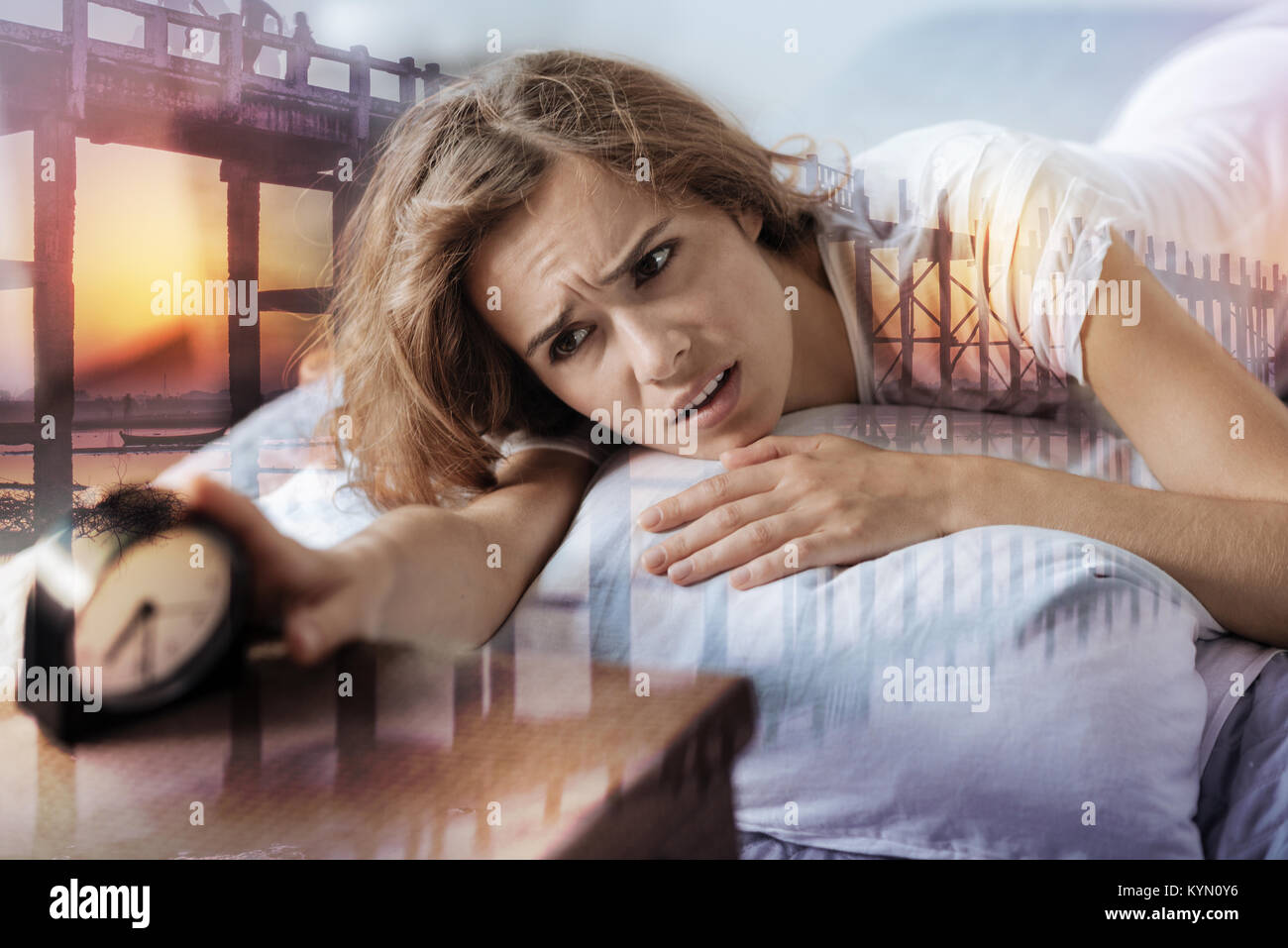 Emotional female person taking alarm clock Stock Photo - Alamy
