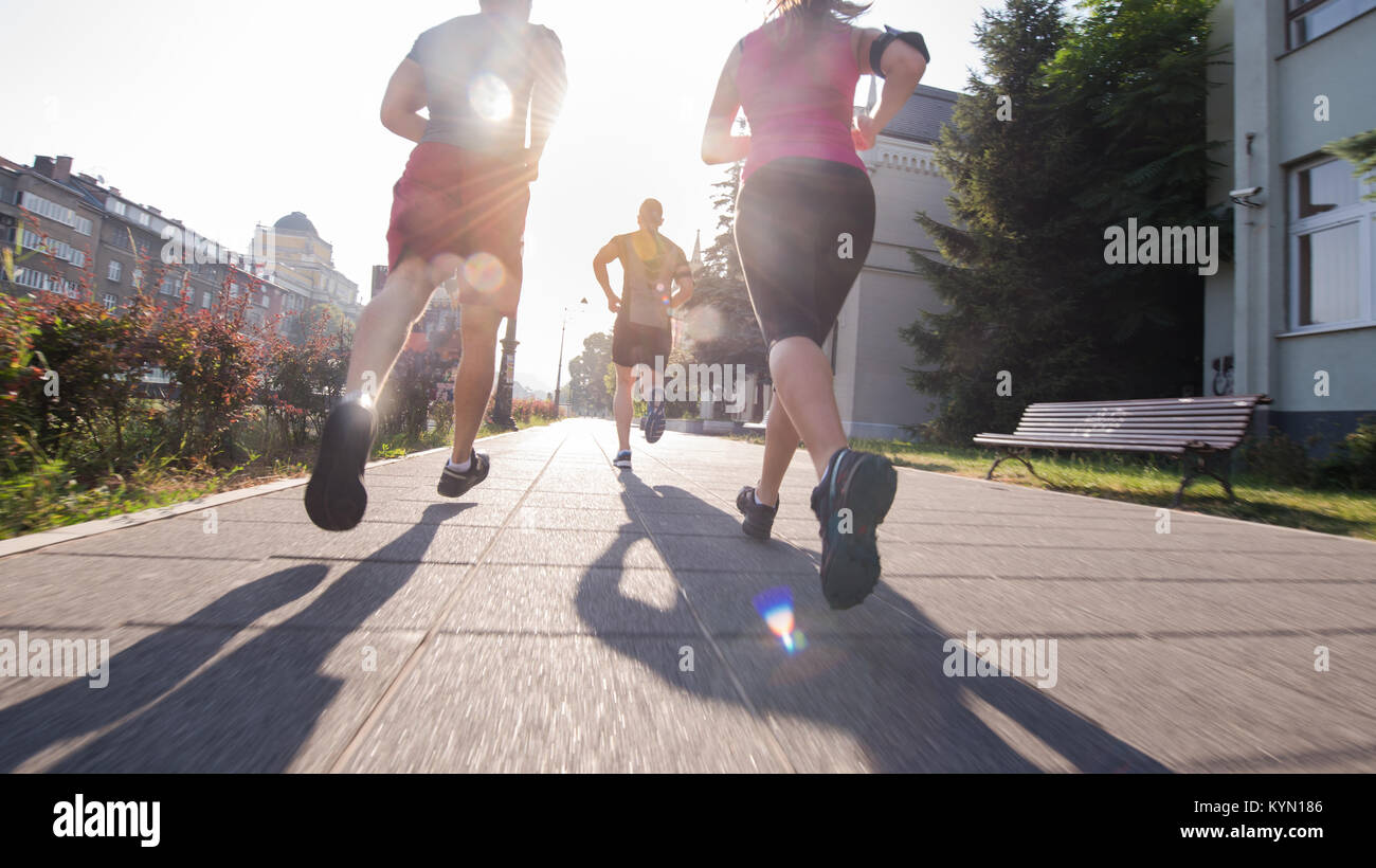group of young sporty people jogging at sunny morning in the city Stock ...