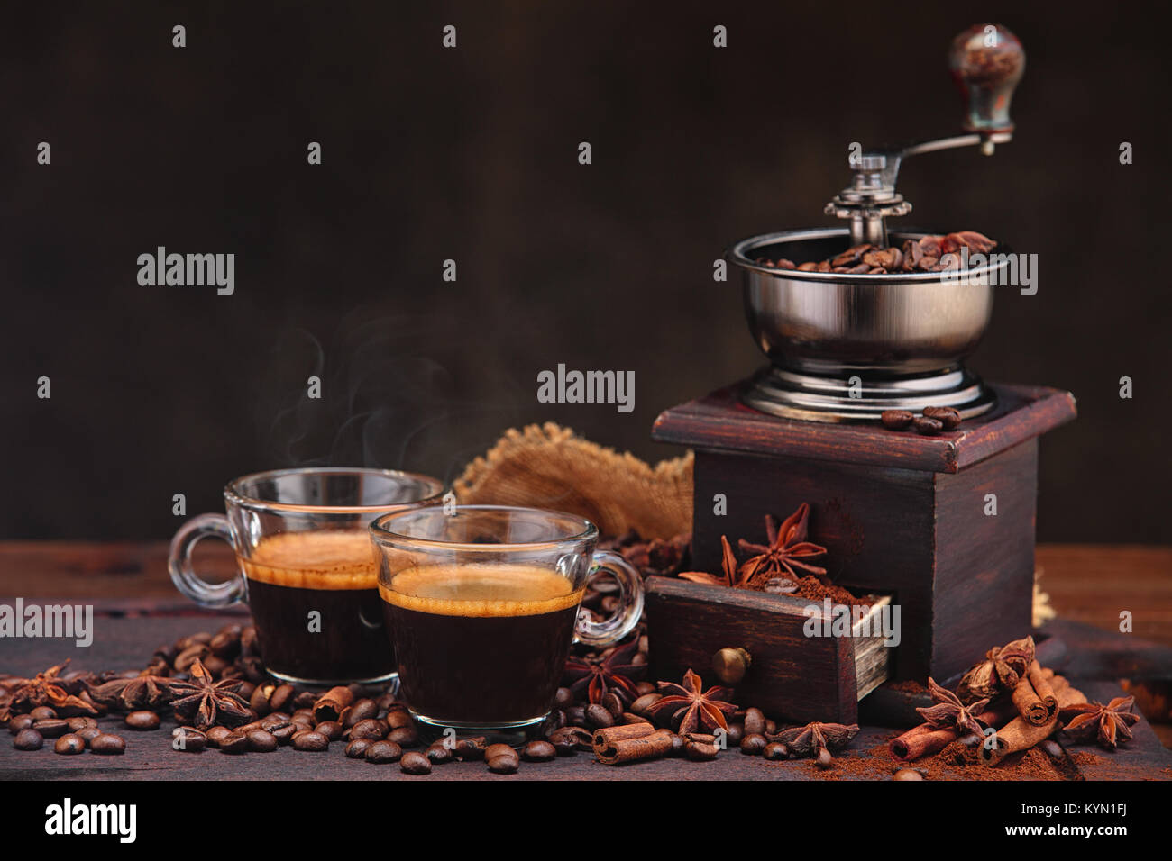 Cup of coffee and coffee ingredients on wooden table with cinnamon and ...