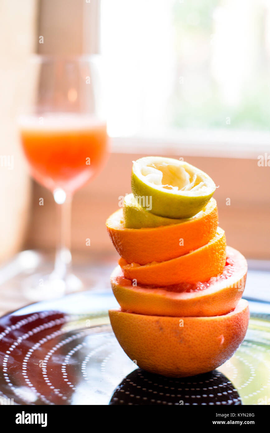 citrus fruit squeezed in the kitchen stacked peels to form a tower ...