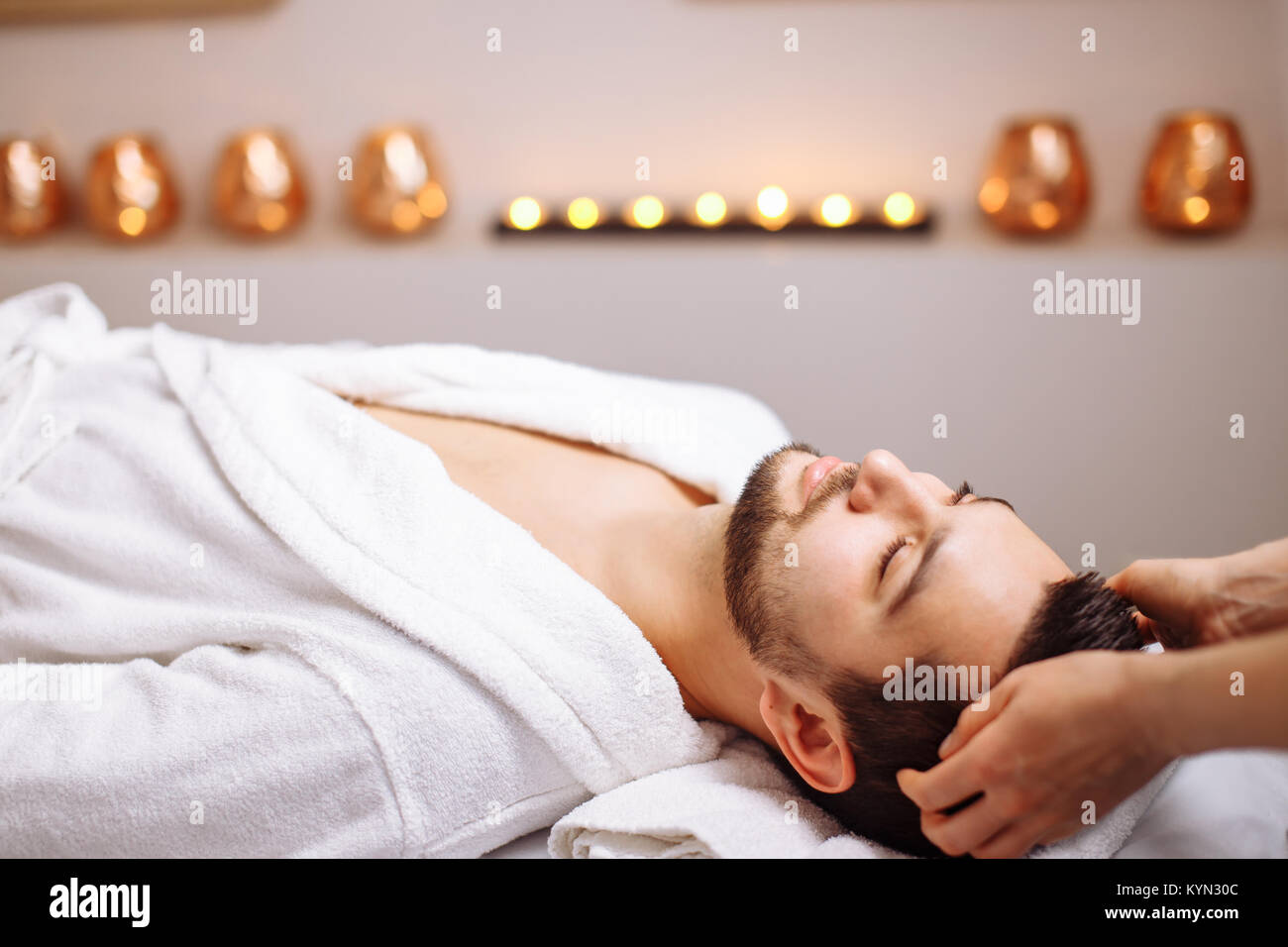 Handsome man during spa massaging session Stock Photo - Alamy