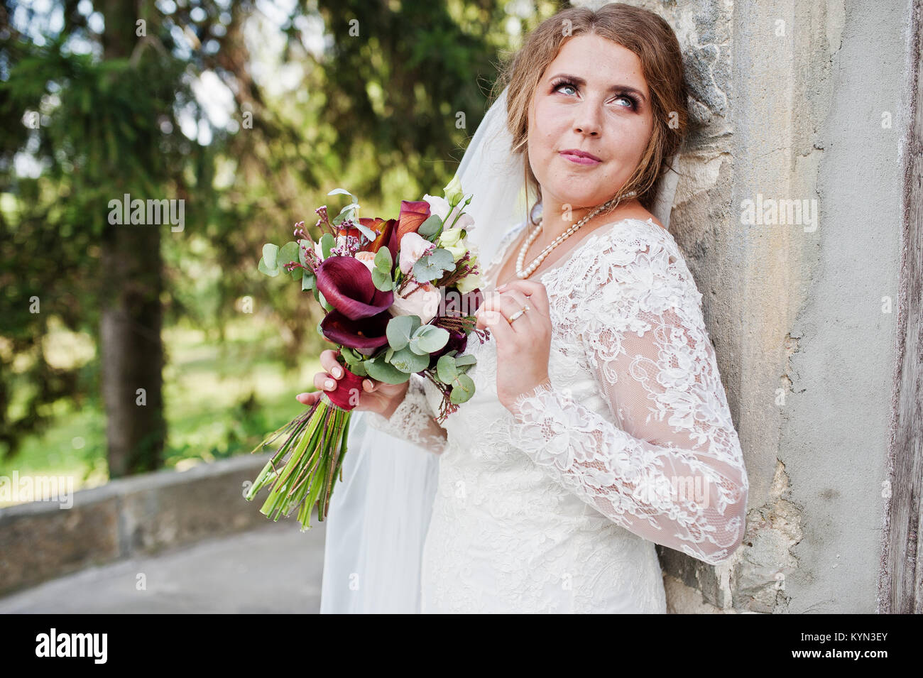Lonely bride posing in her white dress on her own in the park Stock ...