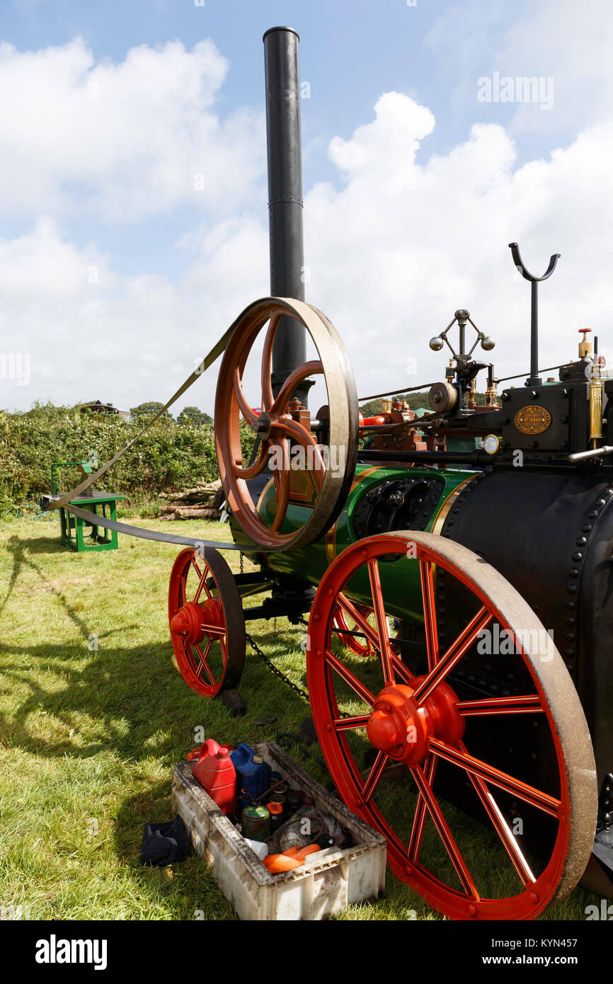 A stationary steam engine driving an unguarded saw bench using a dangerous unprotected belt ...
