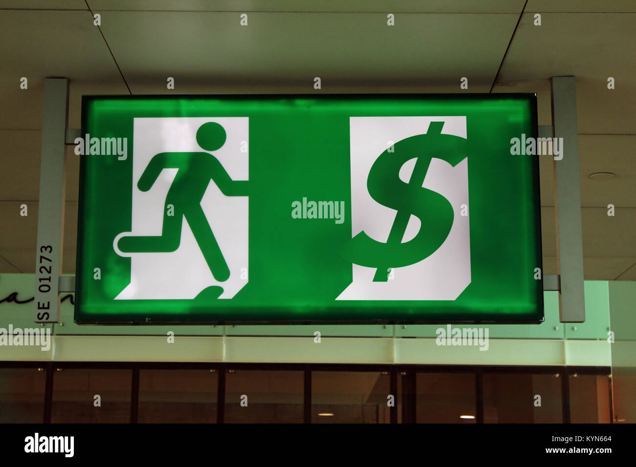 Sign with man figure running after dollar symbol Stock Photo - Alamy