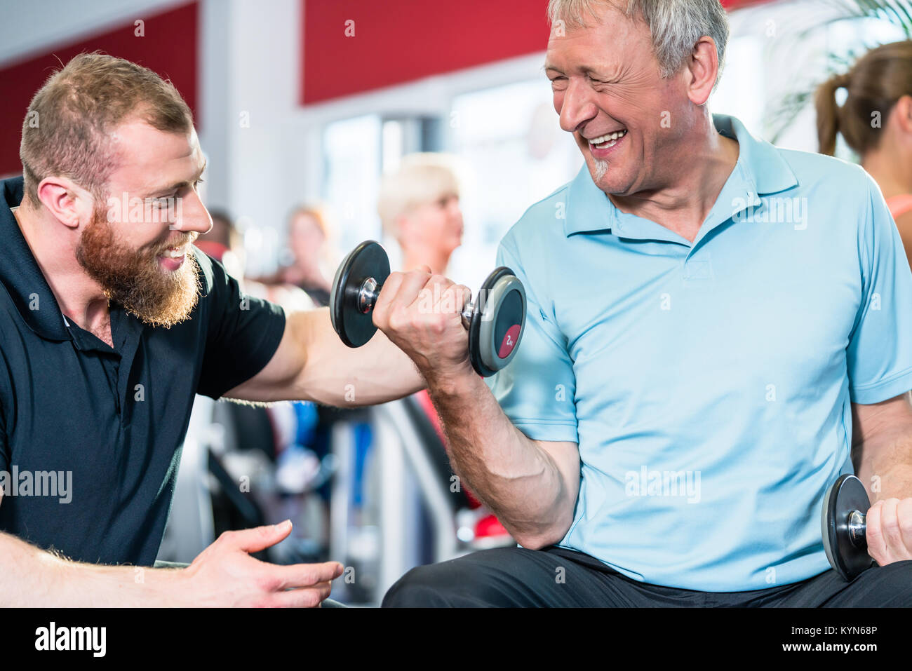 Senior man working out with personal trainer at the gym Stock Photo - Alamy