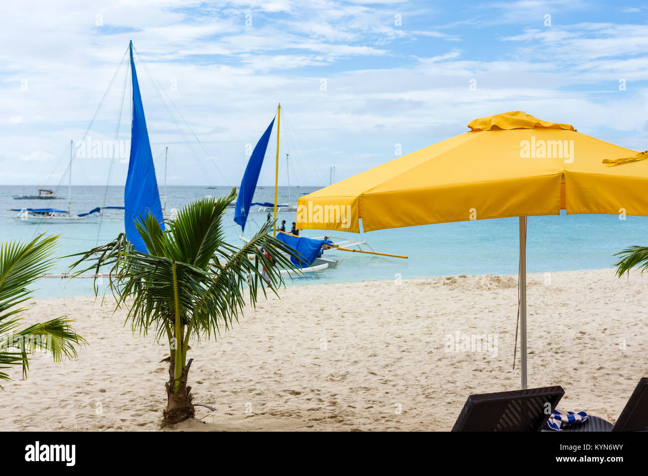 Boracay Beach, small palm trees and a yellow parasol in the foreground ...